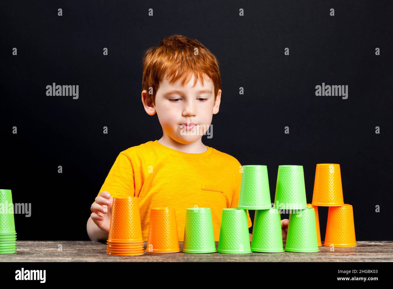 plastic green and orange cups that the child put together during the ...