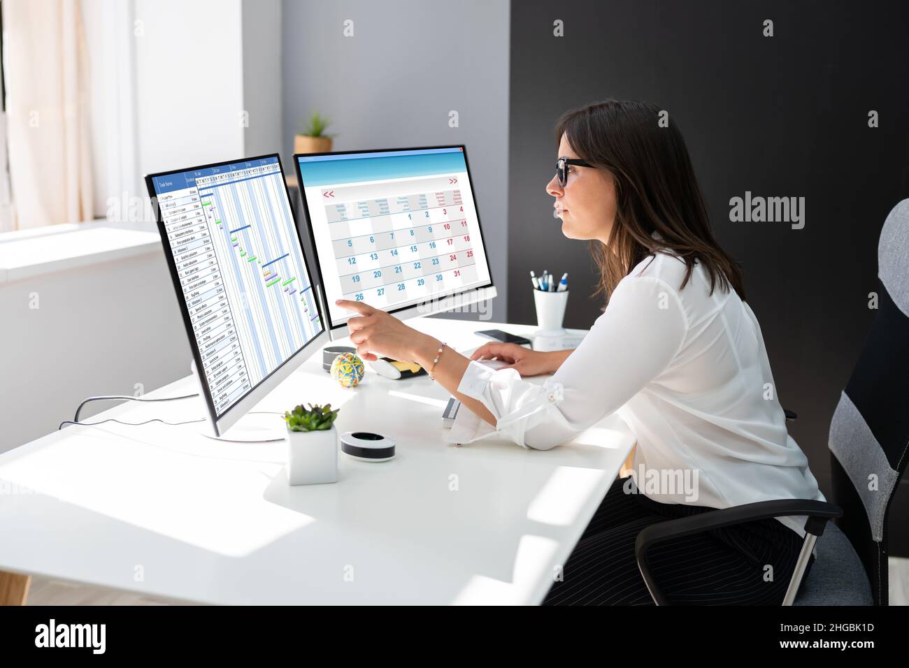 Employee Working On Calendar Schedule And Staff Time Sheet Stock Photo ...