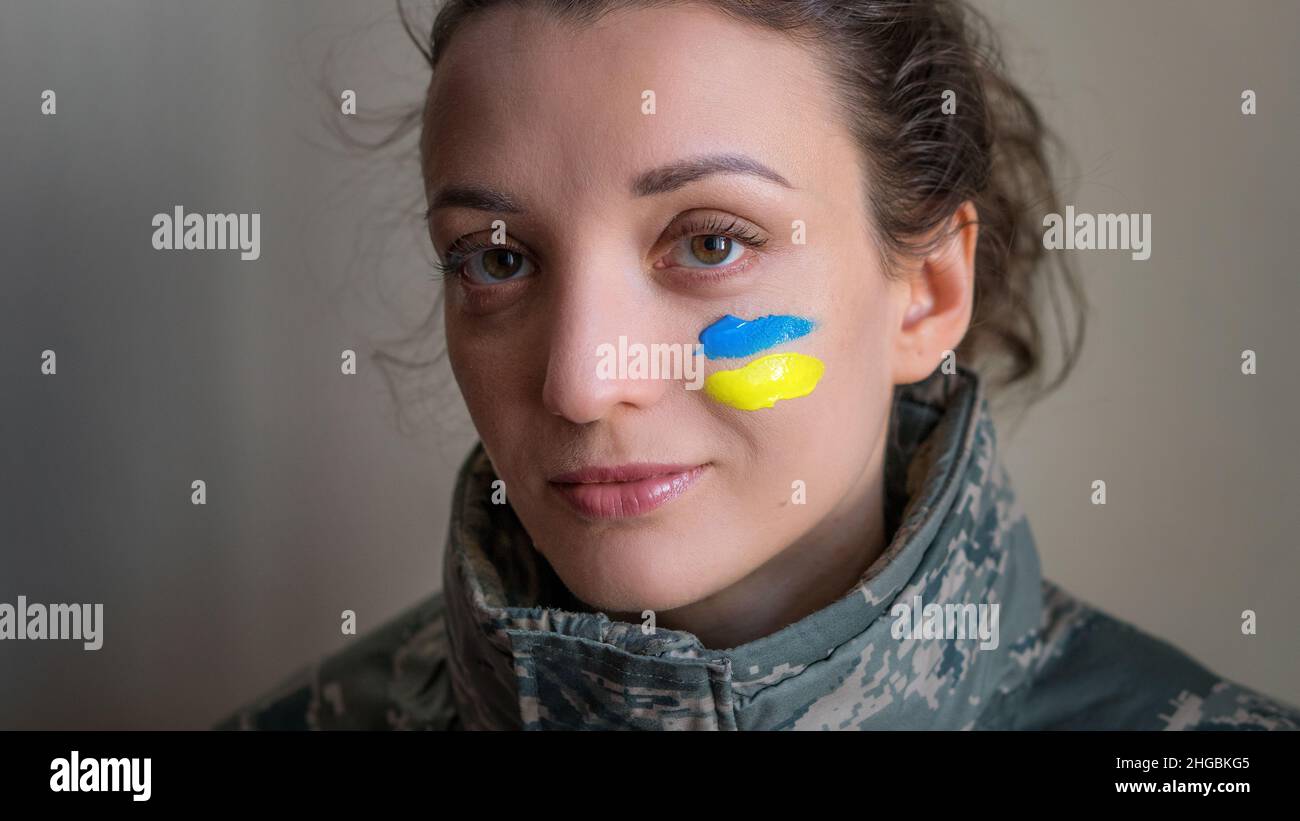 Indoor portrait of young girl with blue and yellow ukrainian flag on ...