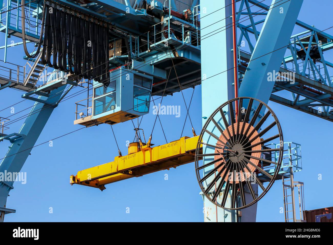 Gantry crane and cable reel in docklands. Motorized industrial ...
