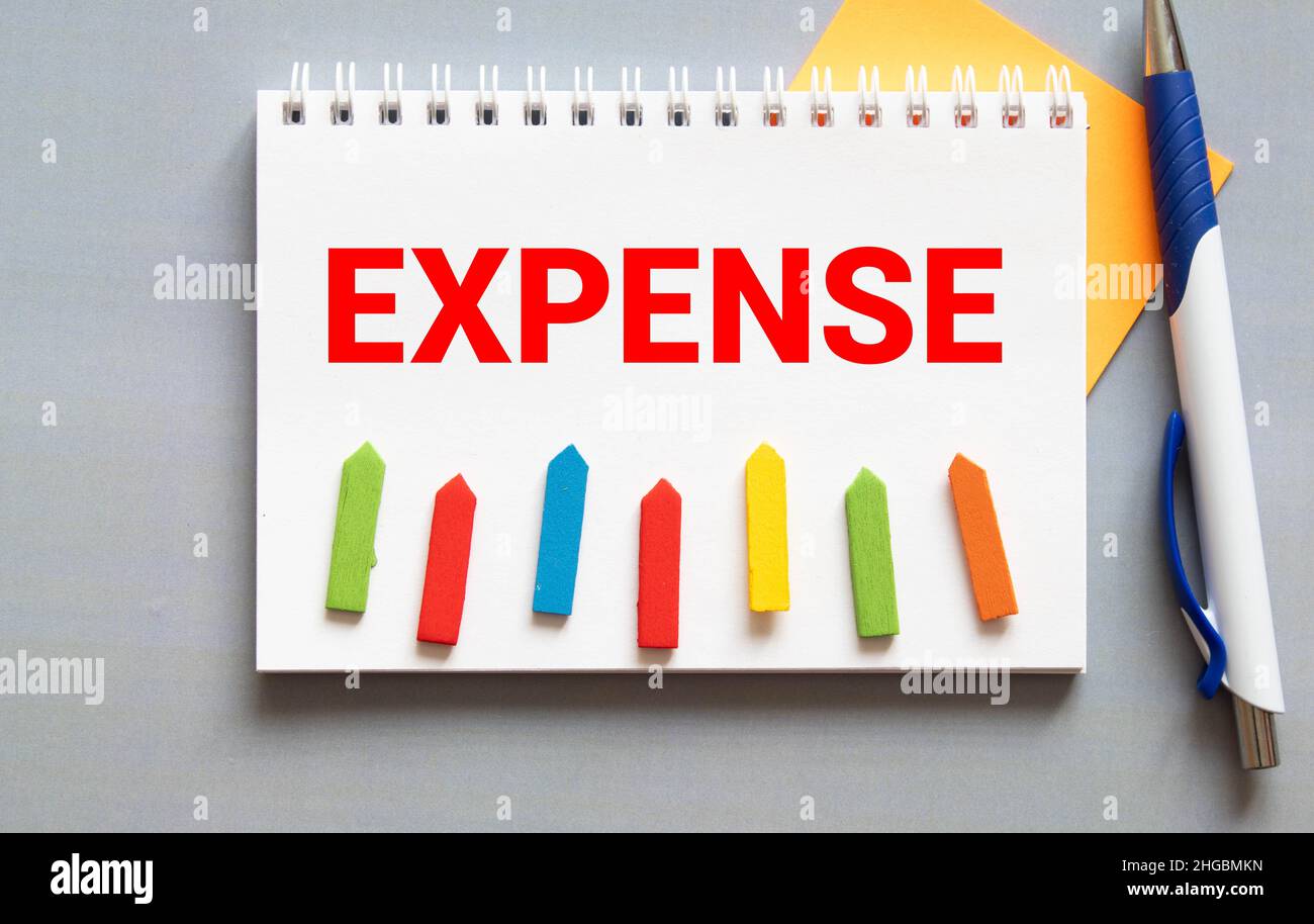 Notebook with the words Expenses. Outflow of money as payment for goods ...