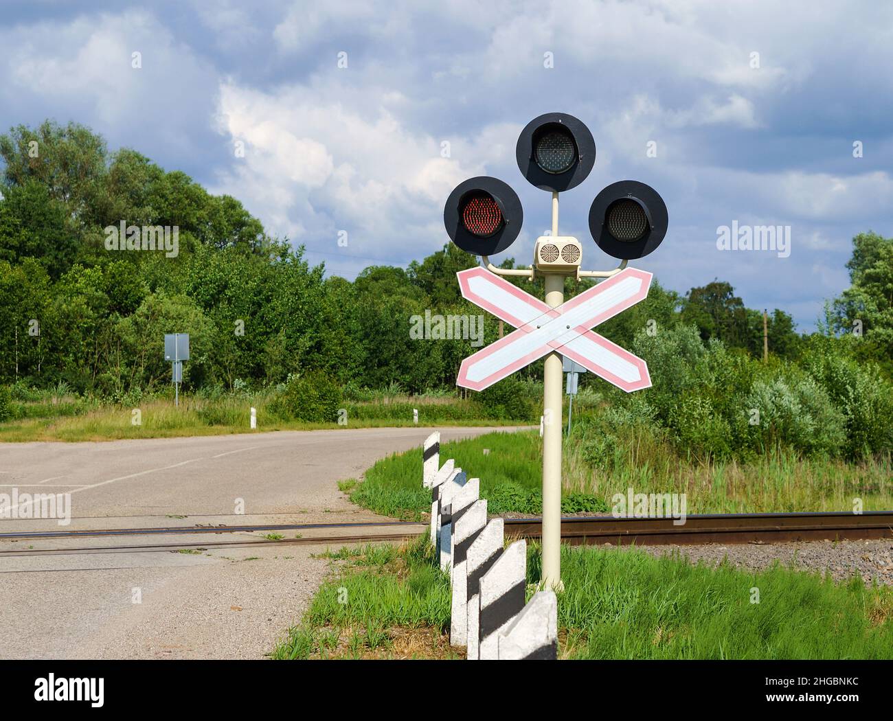 Red traffic light at the railway crossing. Attention motorists. Warning ...