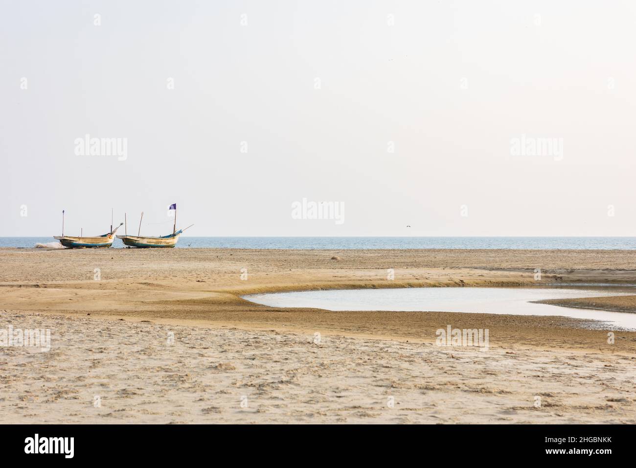 View of the river flowing through the beach and meeting the sea forming ...