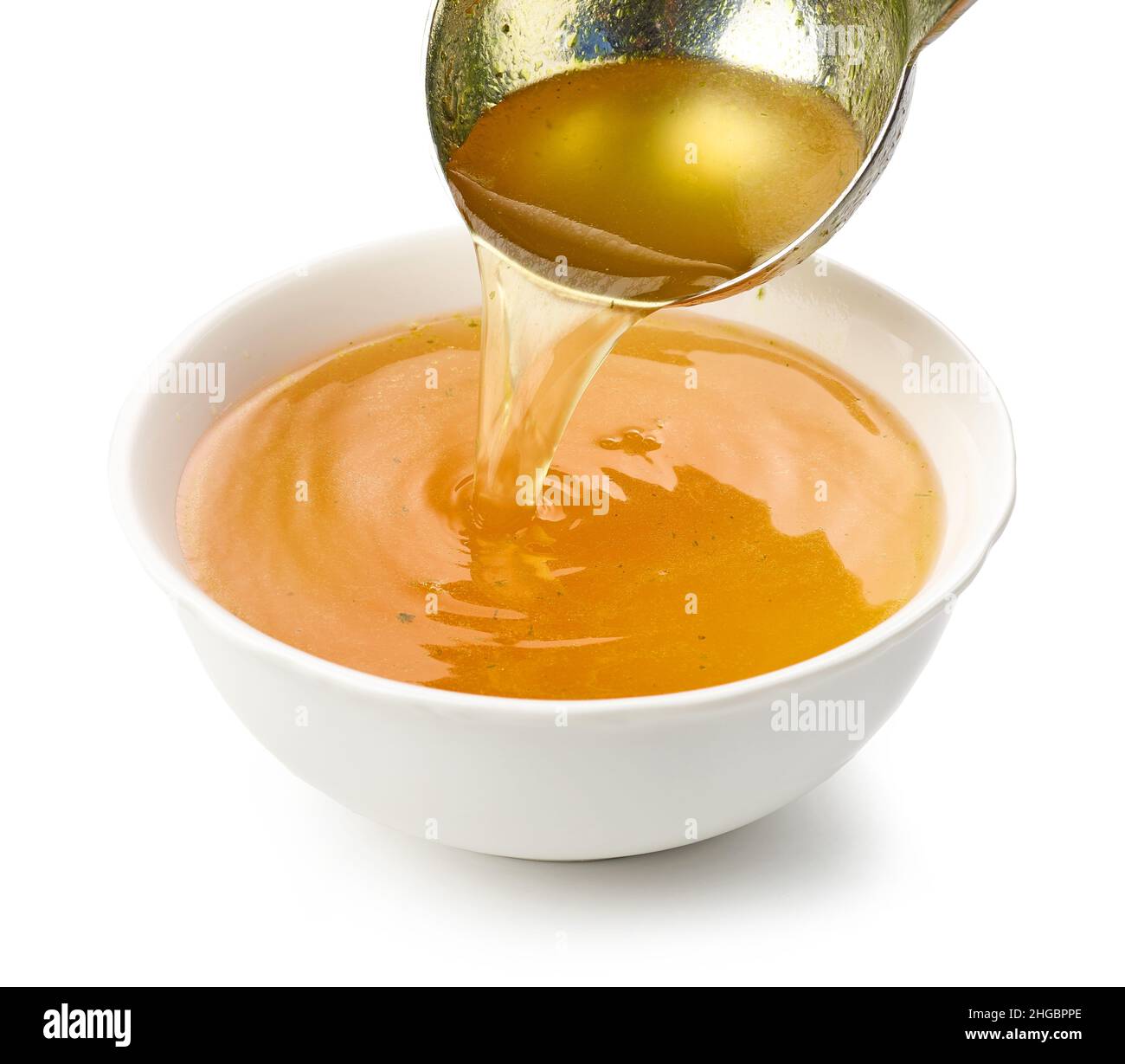 chicken broth pouring into bowl isolated on white background Stock ...