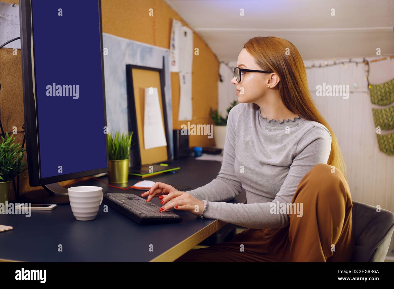 Stay home, a chic girl works in a homely atmosphere. Girl freelancer ...