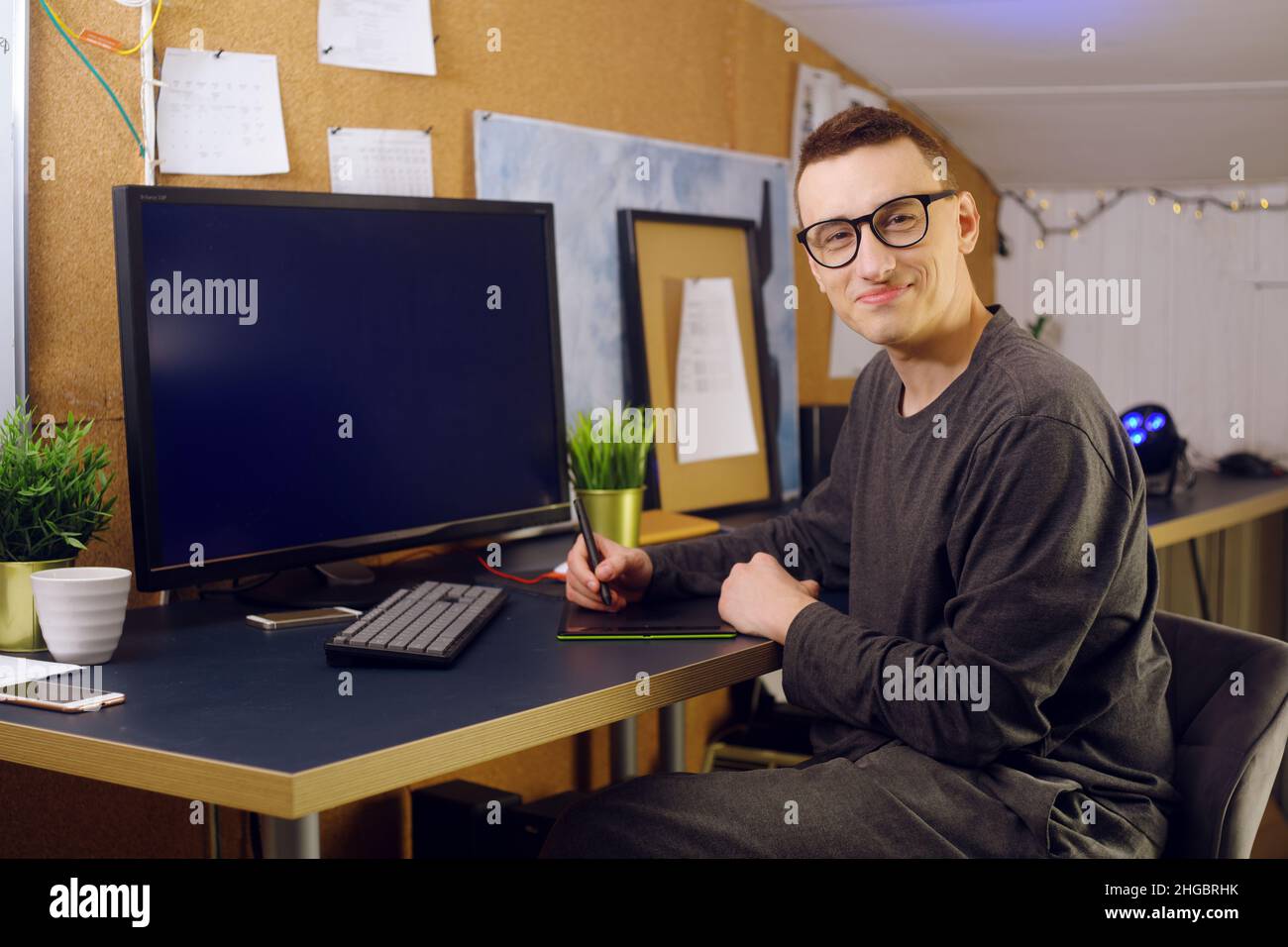 Man works home looks tablet hi-res stock photography and images - Alamy