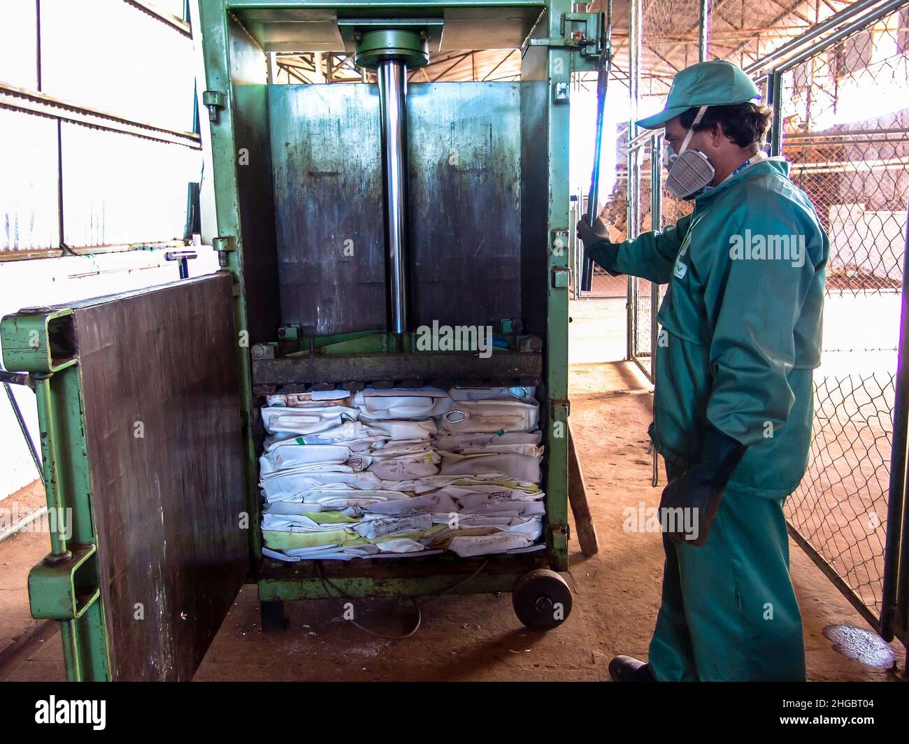 Piracicaba, Sao Paulo, Brazil, July 06, 2007. Worker presses plastic ...