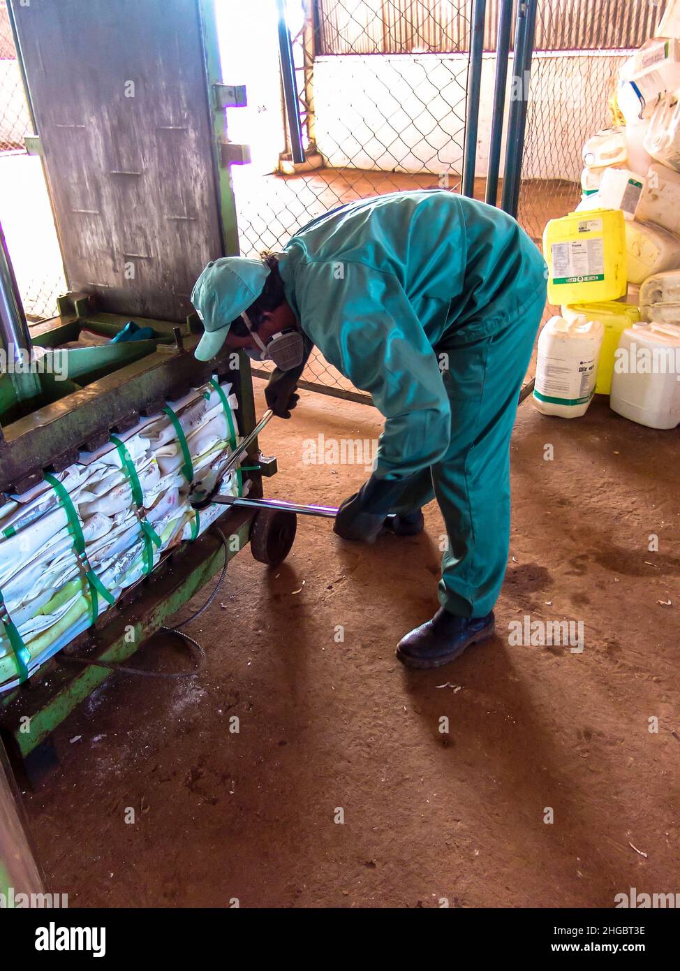 Piracicaba, Sao Paulo, Brazil, July 06, 2007. Worker presses plastic ...