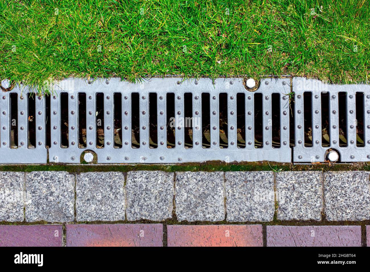 gray grating of the drainage system for drainage of rainwater in the ...