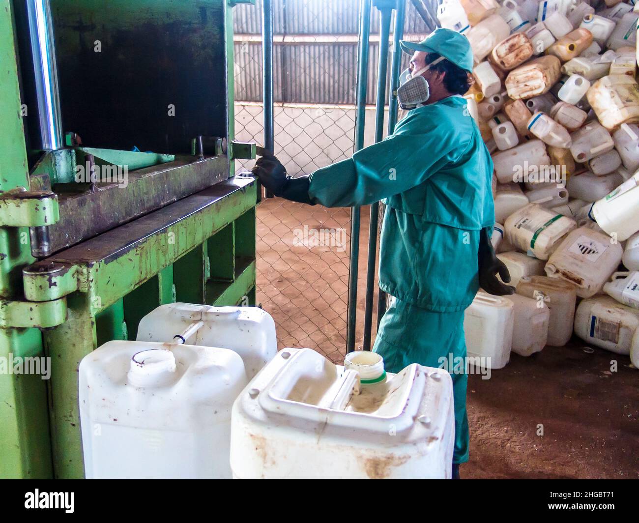 Piracicaba, Sao Paulo, Brazil, July 06, 2007. Worker presses plastic ...