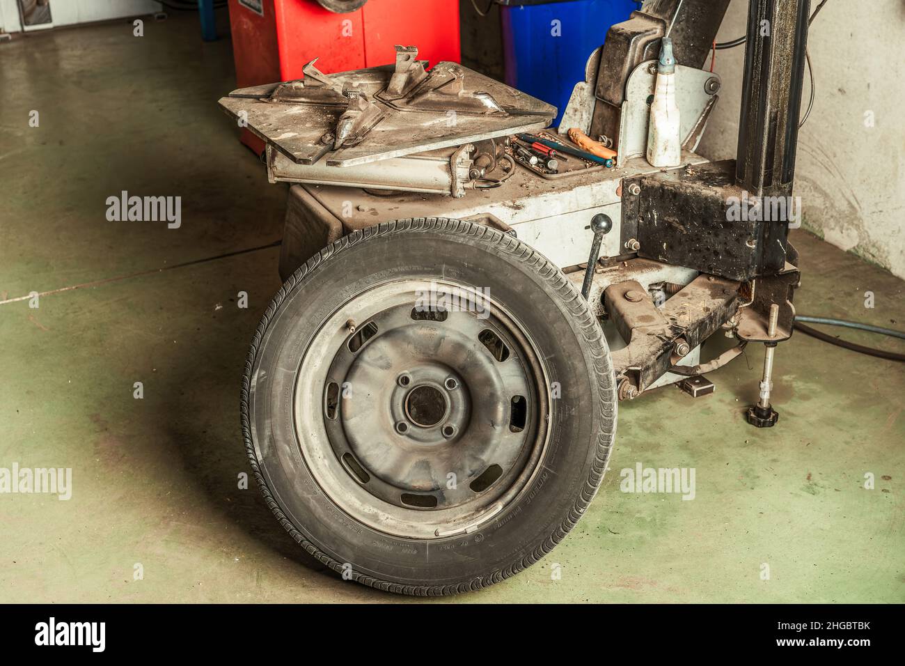 Mechanic's workshop with a table full of tools and a wheel Stock Photo ...
