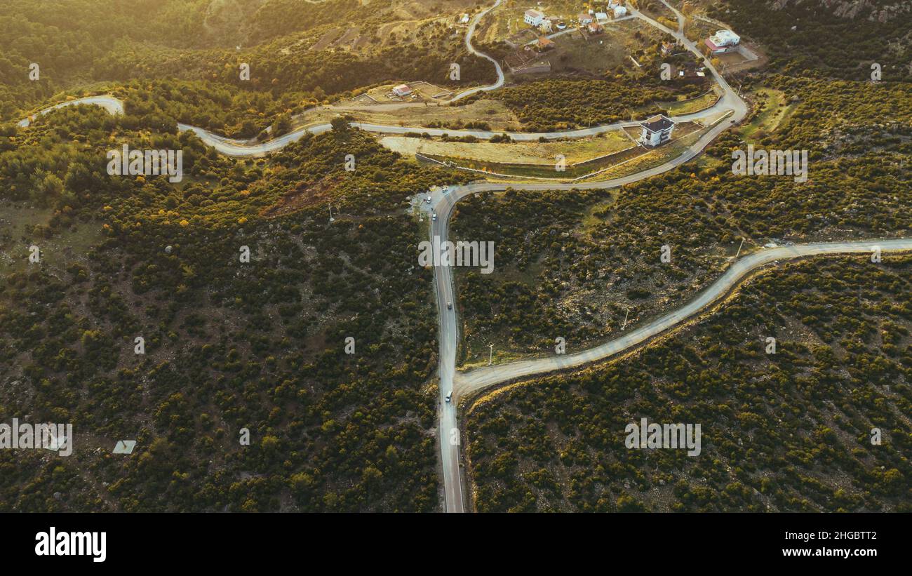 Aerial Top view of a bending single lane road among bushes Stock Photo ...