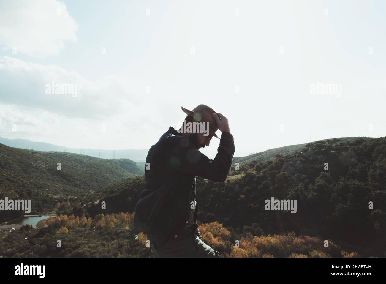 Portrait of a 30s man with a fedora and shirt at countryside on the ...