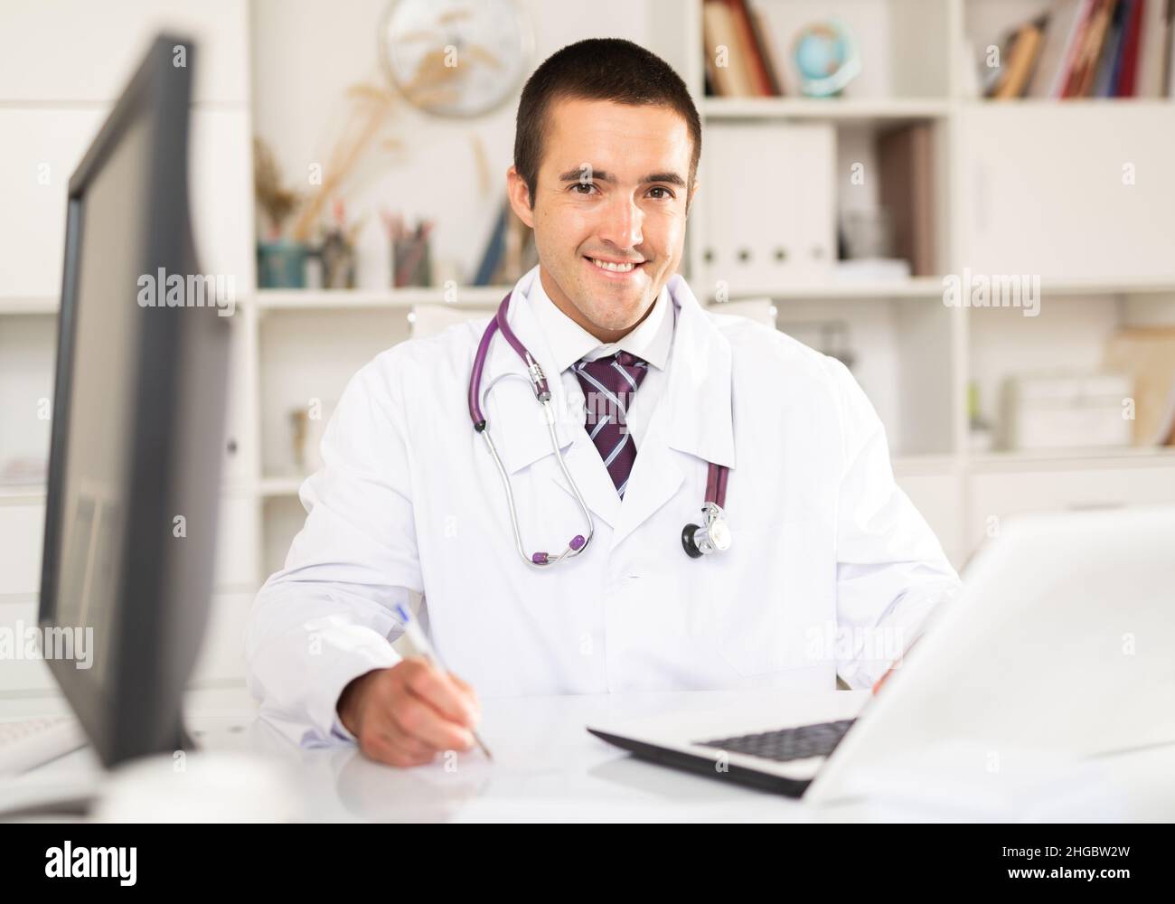 Polite male therapist holding medical hi-res stock photography and ...
