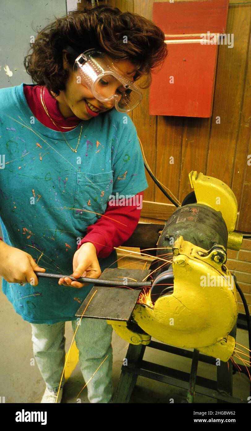 Austin, Texas USA 1990 Student using a shop grinder safely in metal ...
