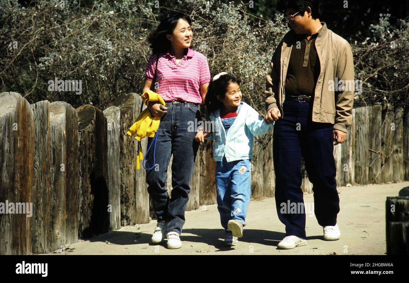 Austin, Texas USA 1988: Asian-American family walking on a sunny day in ...