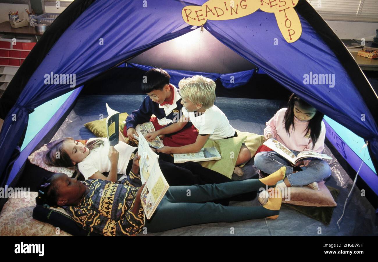 Austin, Texas USA 1994: Third grade reading tent in multi-ethnic ...