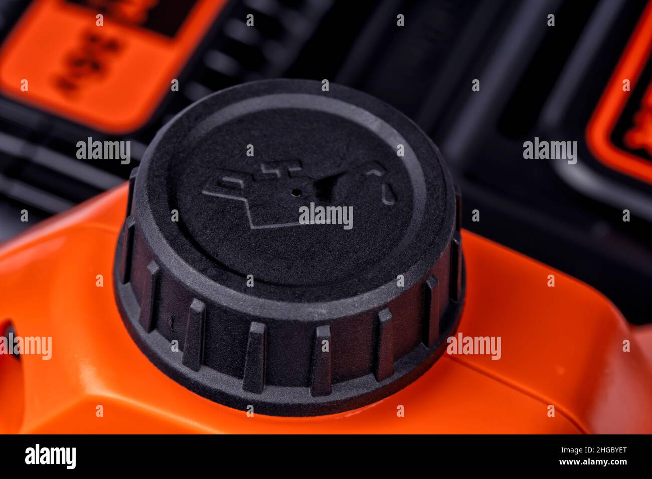 A detail of the cap of the oil tank of a chainsaw Stock Photo - Alamy