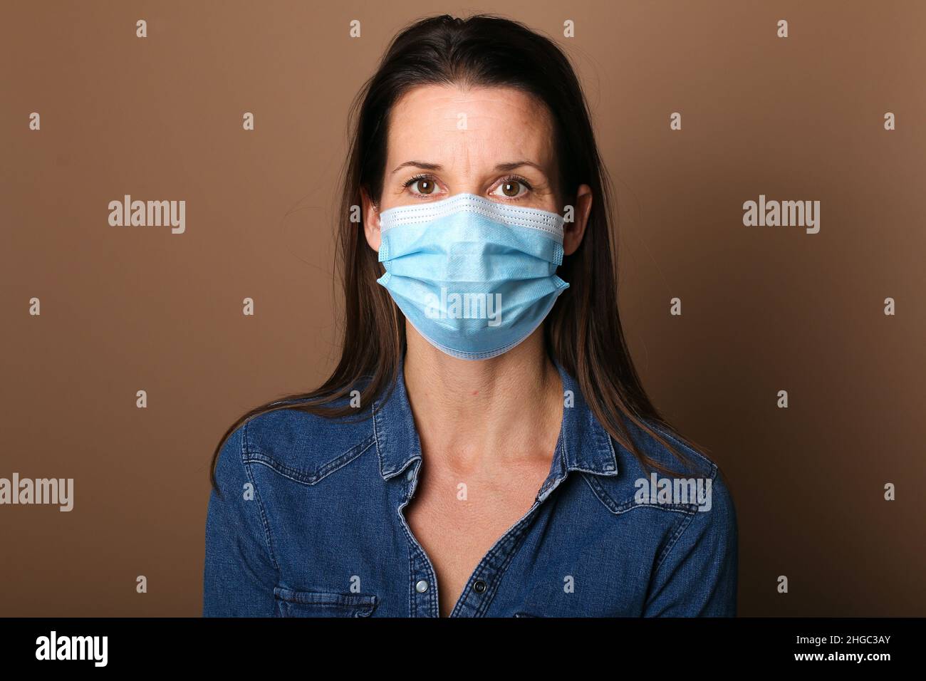 Beautiful woman wearing a mouth mask Stock Photo - Alamy