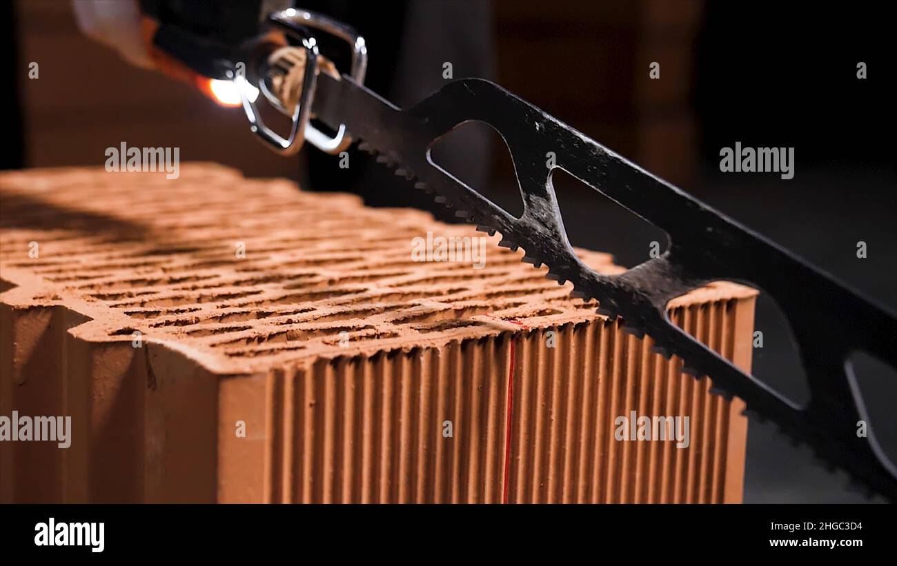 Close up of electric cutting machine for small ceramic blocks turning ...