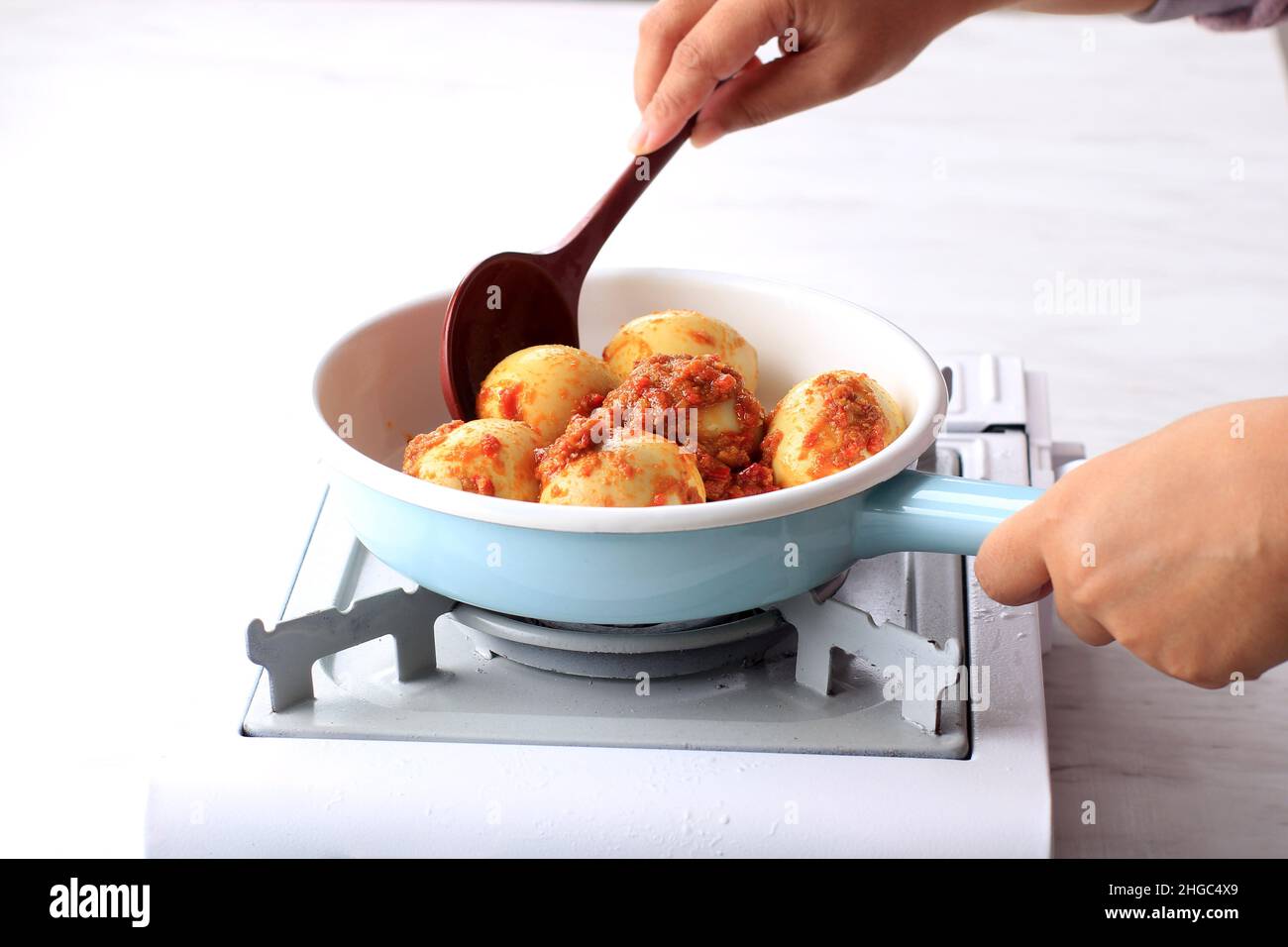Cooking Process: Asian Female Hand Cooking Boiled Egg on Red Spicy ...