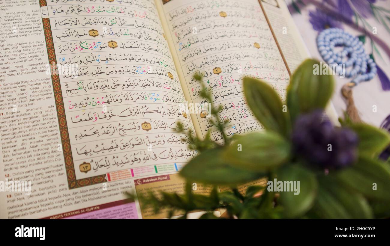 An Open Holy Quran with Prayer Beads on the Side Extreme Close Up Stock ...