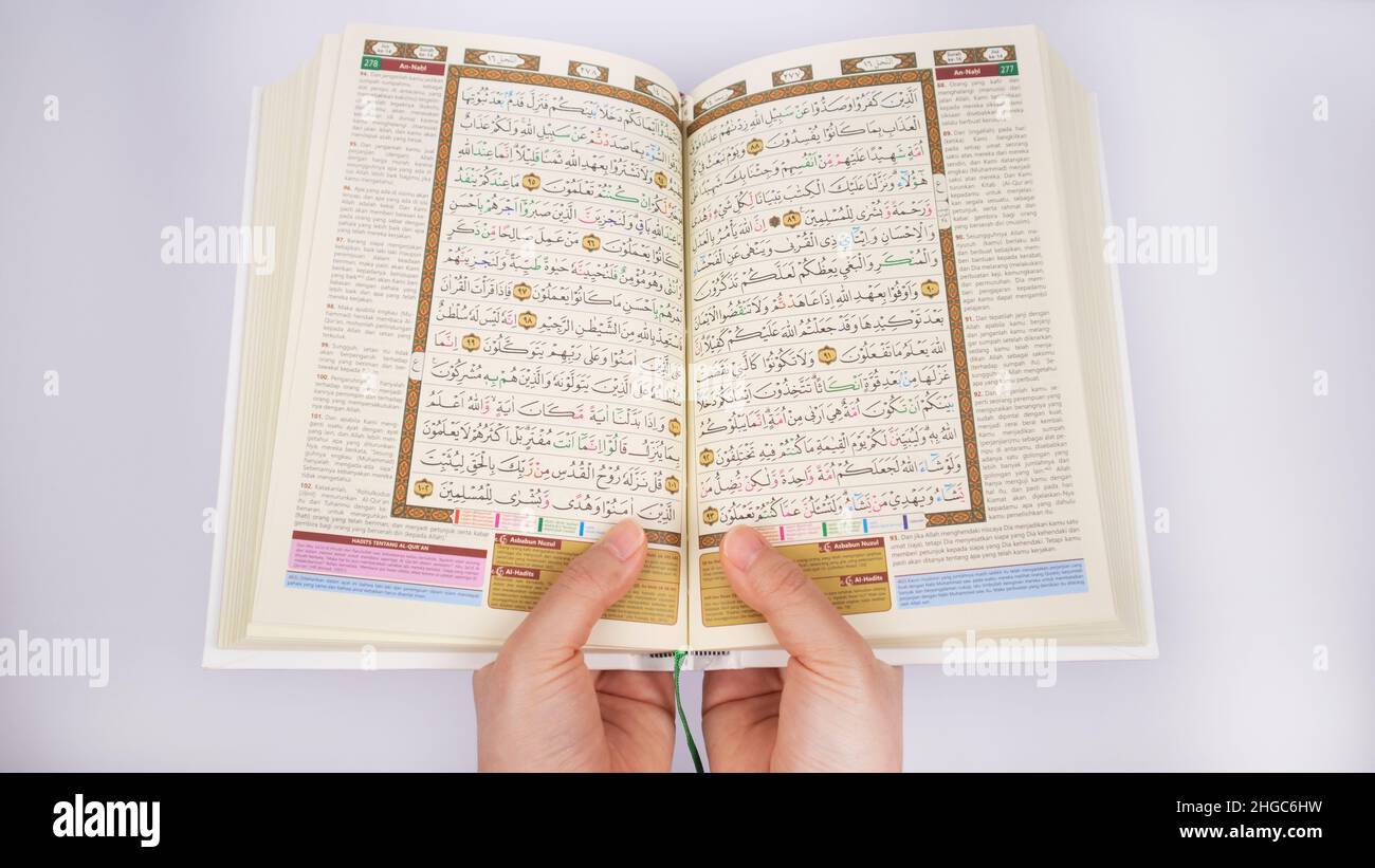Quran in hands hi-res stock photography and images - Alamy