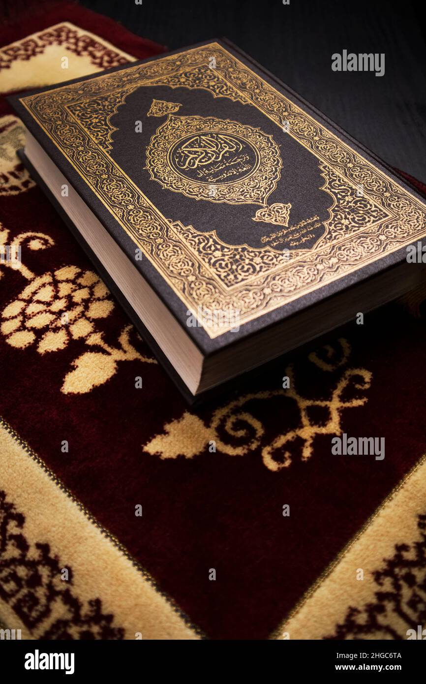 Holy Quran on A Prayer Rug Close Up Background Portrait Stock Photo - Alamy