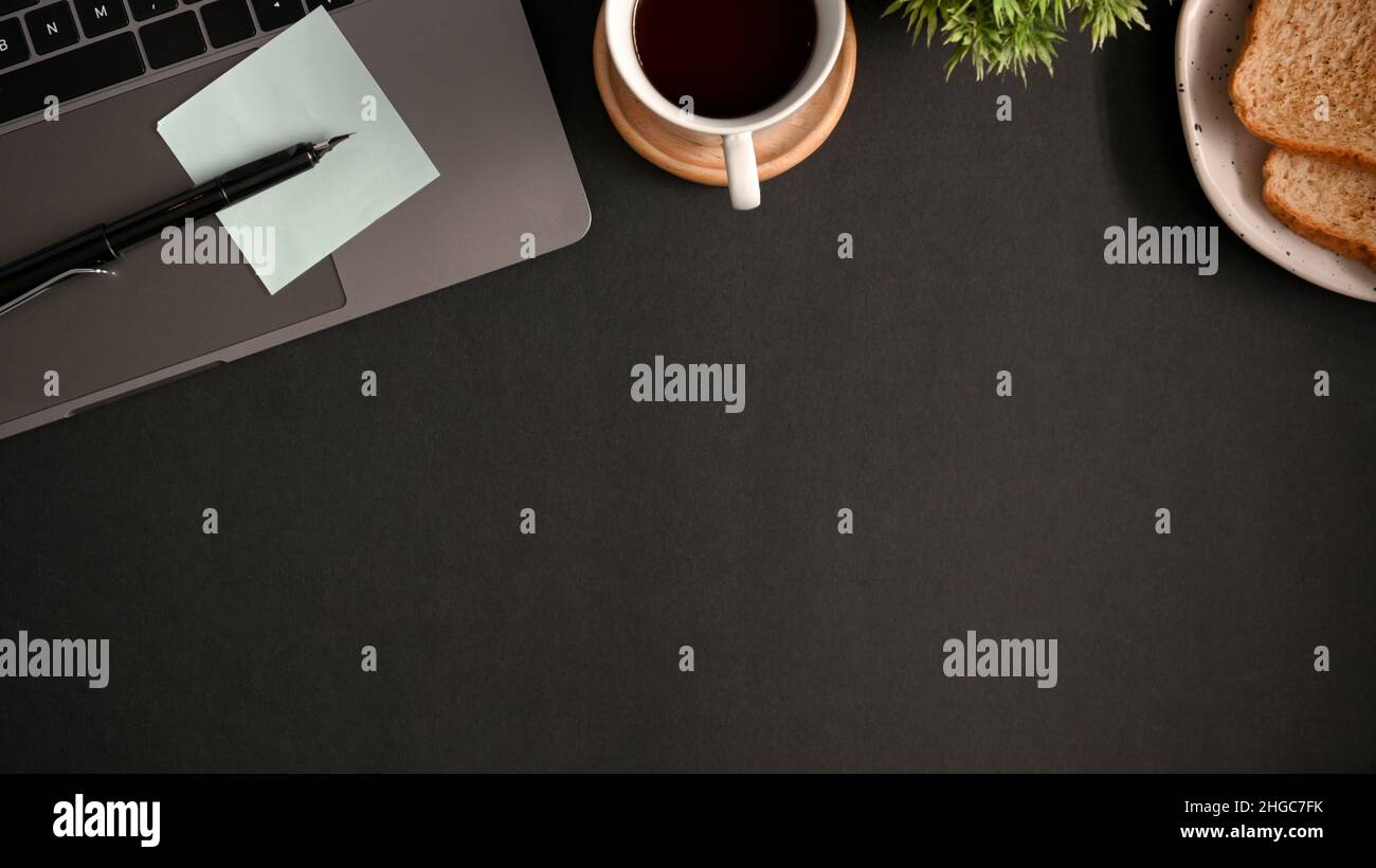 Modern workspace with laptop computer, coffee cup, toasts and copy ...