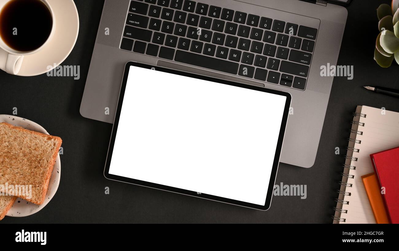 Mockup screen of a digital tablet computer on laptop computer over ...