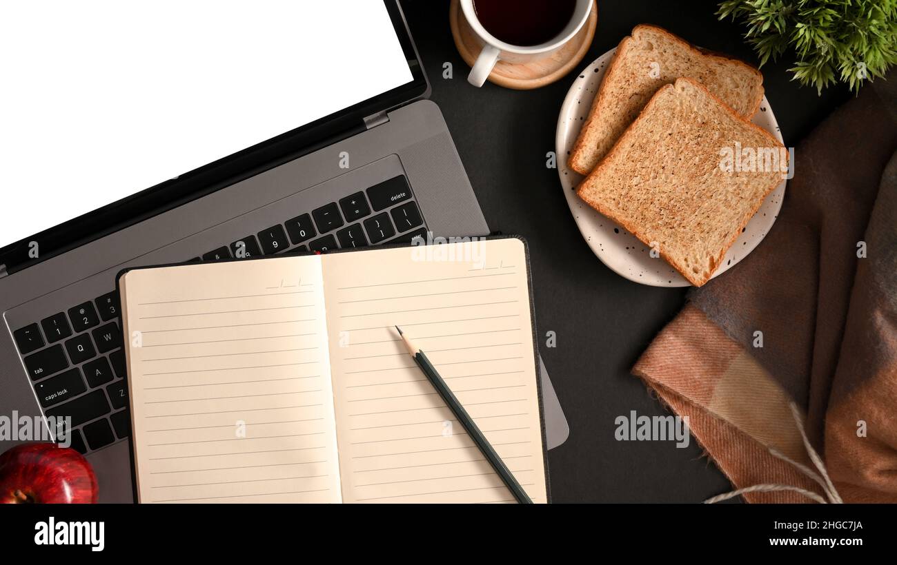 Modern workspace concept, An open notebook on laptop computer mockup ...