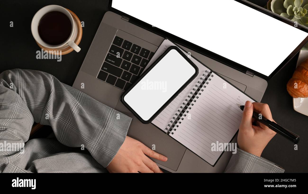 Top view of a busy businesswoman working on laptop computer, looking ...