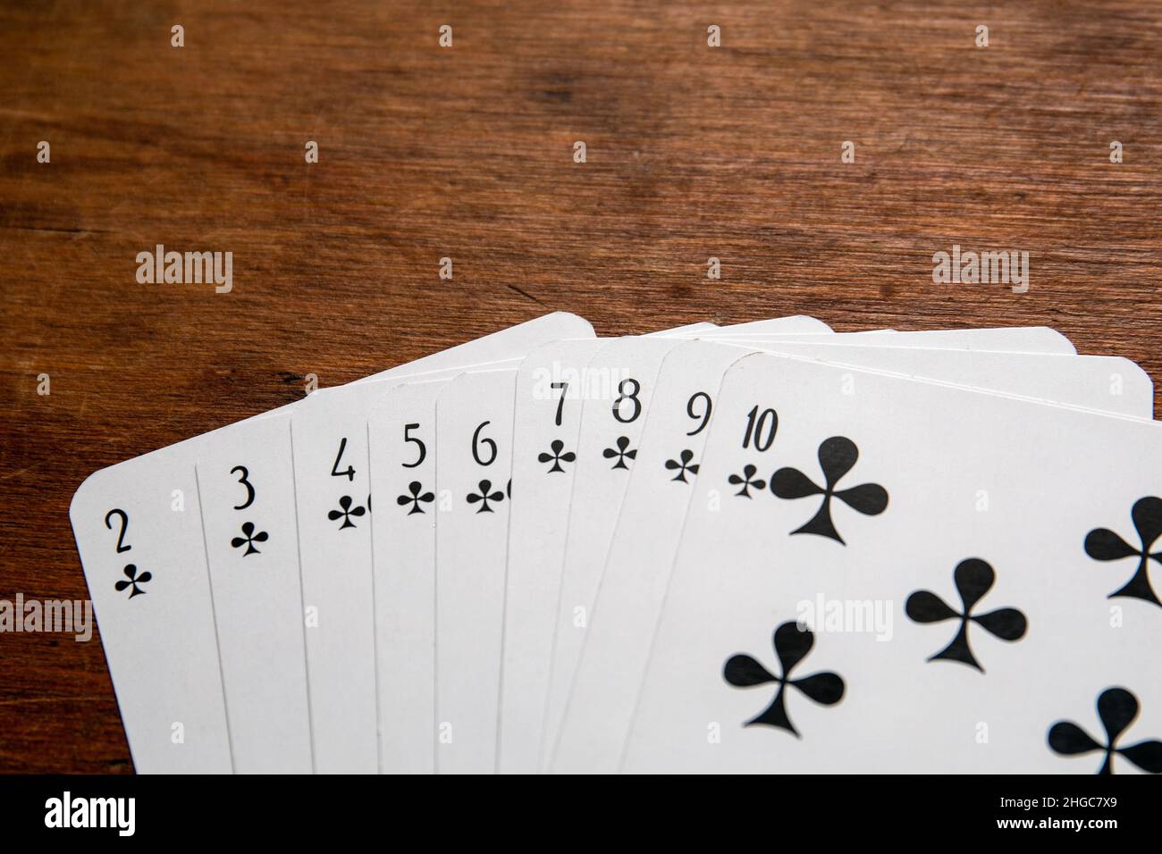 Playing cards on a wooden texture table Stock Photo - Alamy