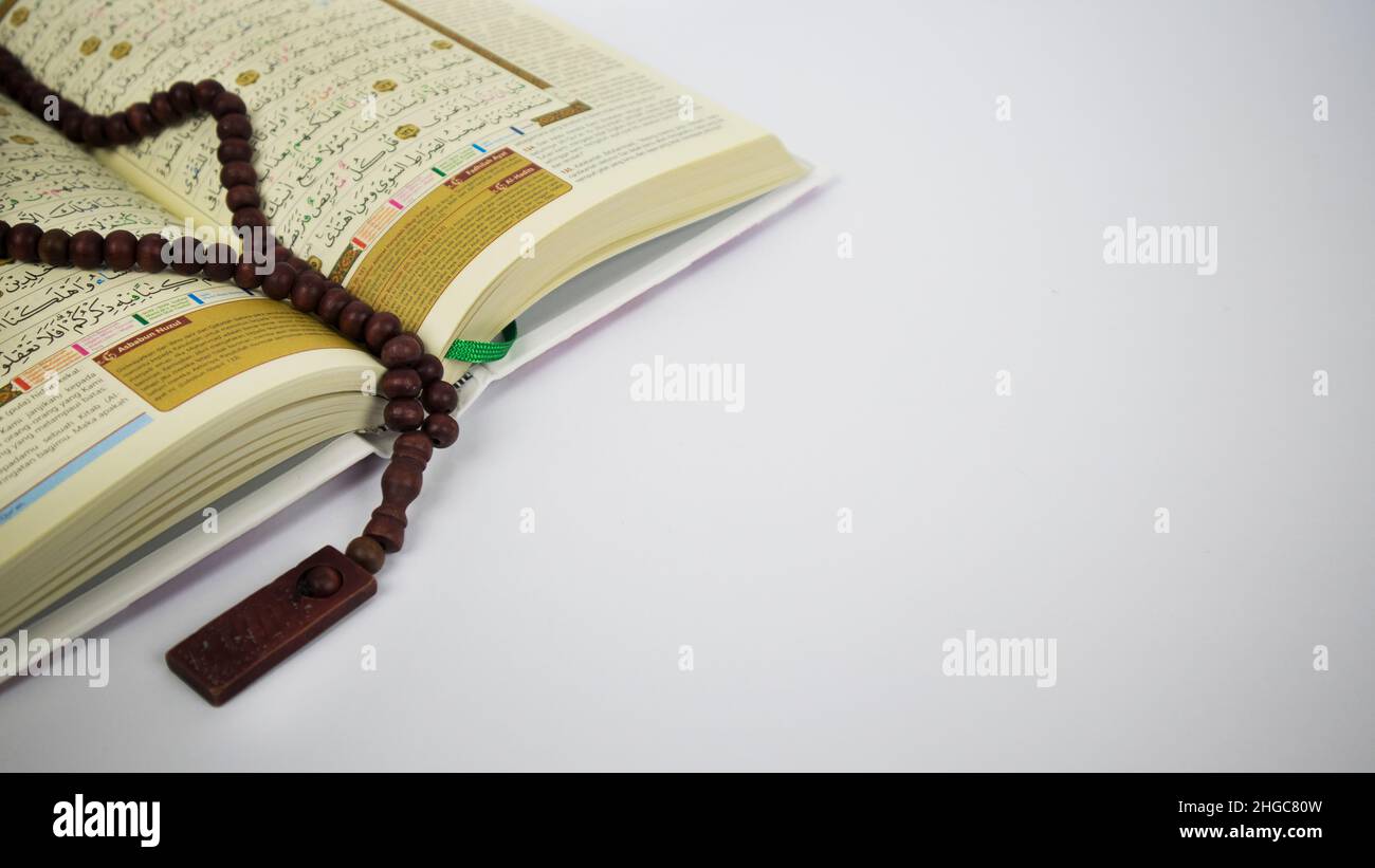 Prayer Beads on Top of an Open Holy Quran Cut Out Stock Photo - Alamy