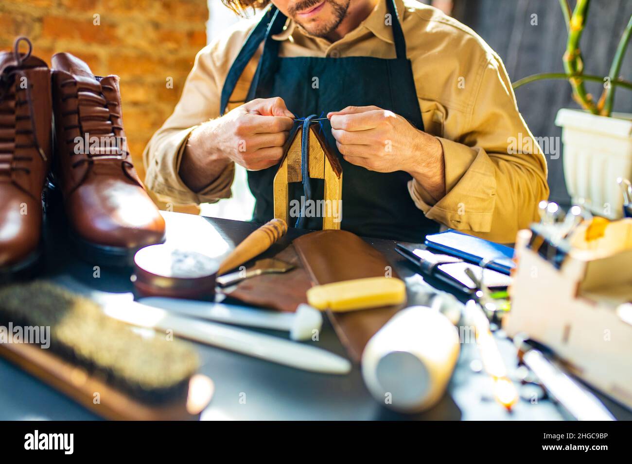 skilled shoemaker make a leather shoes in workshop Stock Photo - Alamy