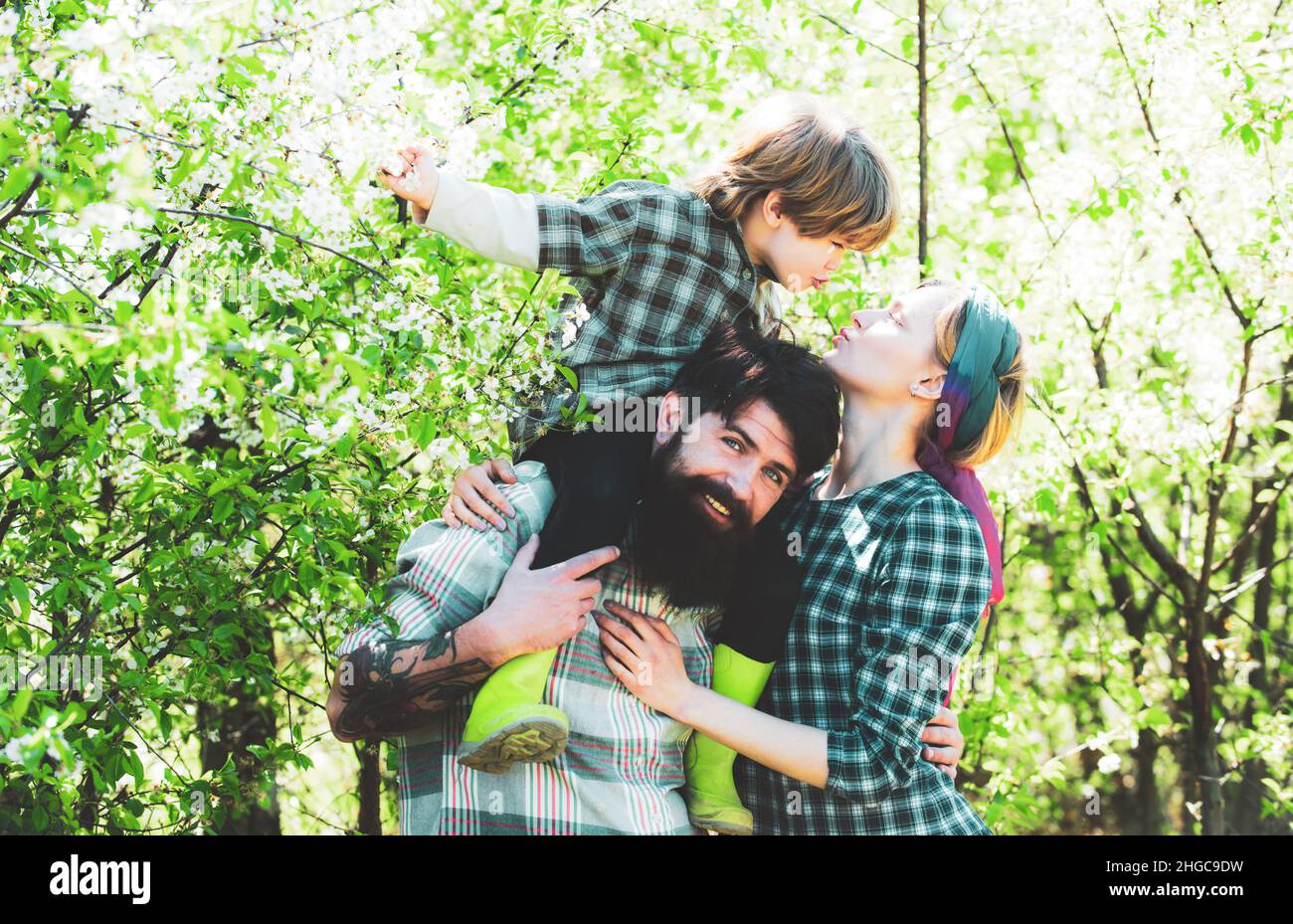 Happy family Farmers working with spud on spring field. Earth concept ...