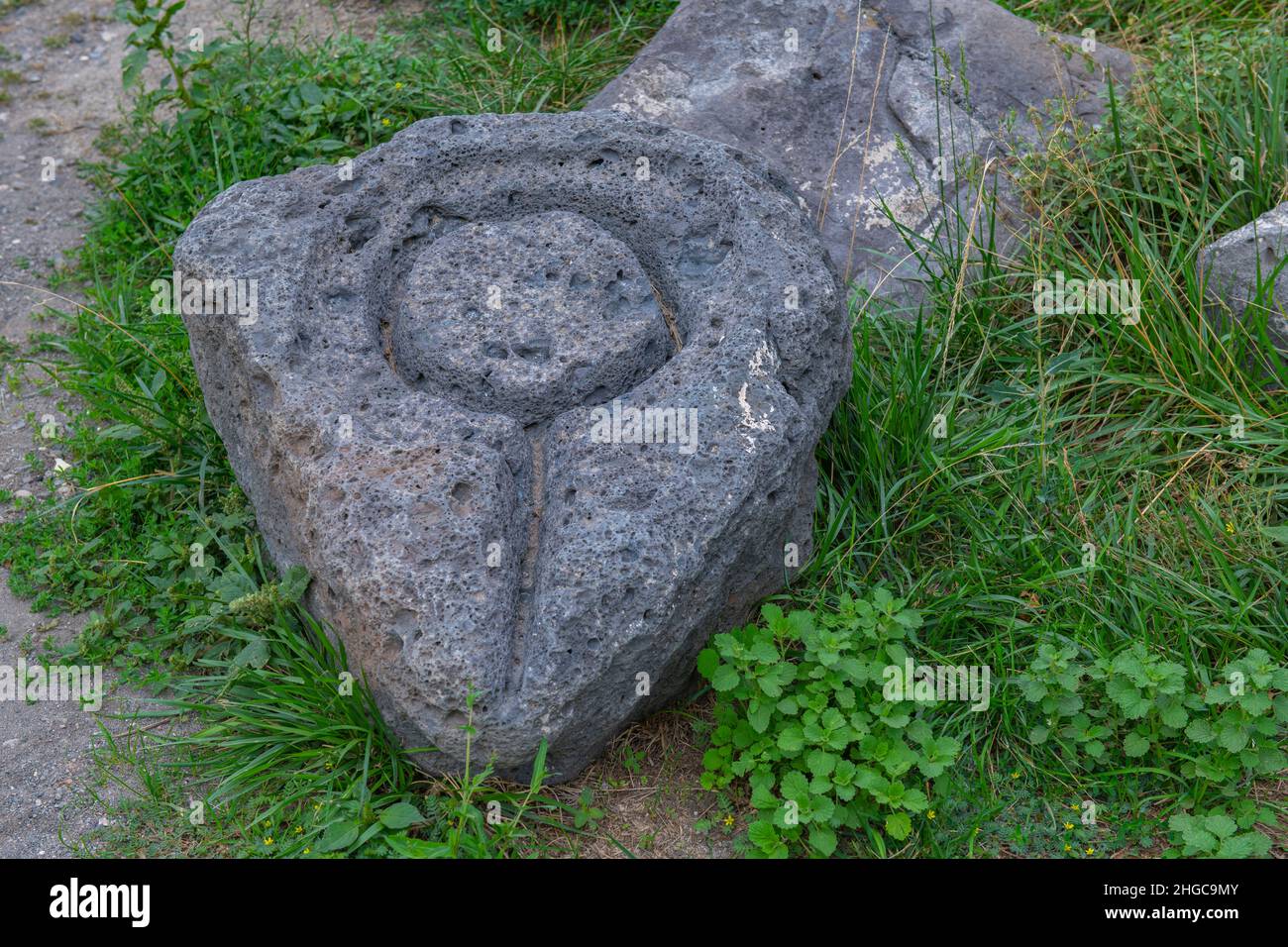 stone in the grass with the emblem Stock Photo - Alamy