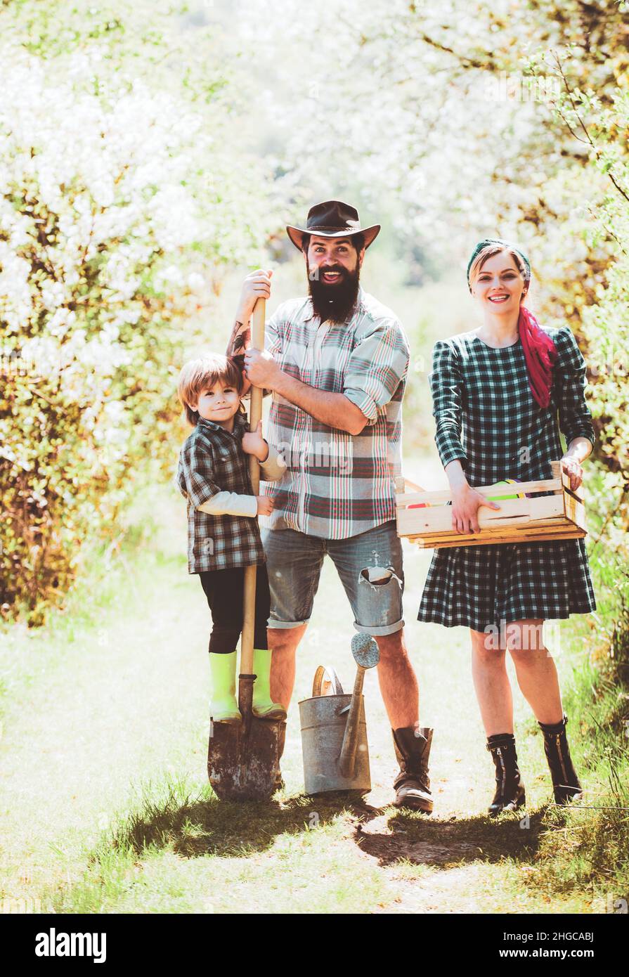 Family planting. Family crop planting at fields Stock Photo - Alamy