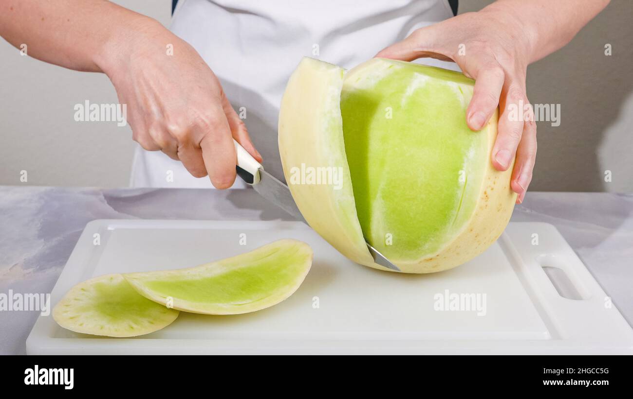 Honeydew melon close up on cutting board. How to peel and seed melon ...