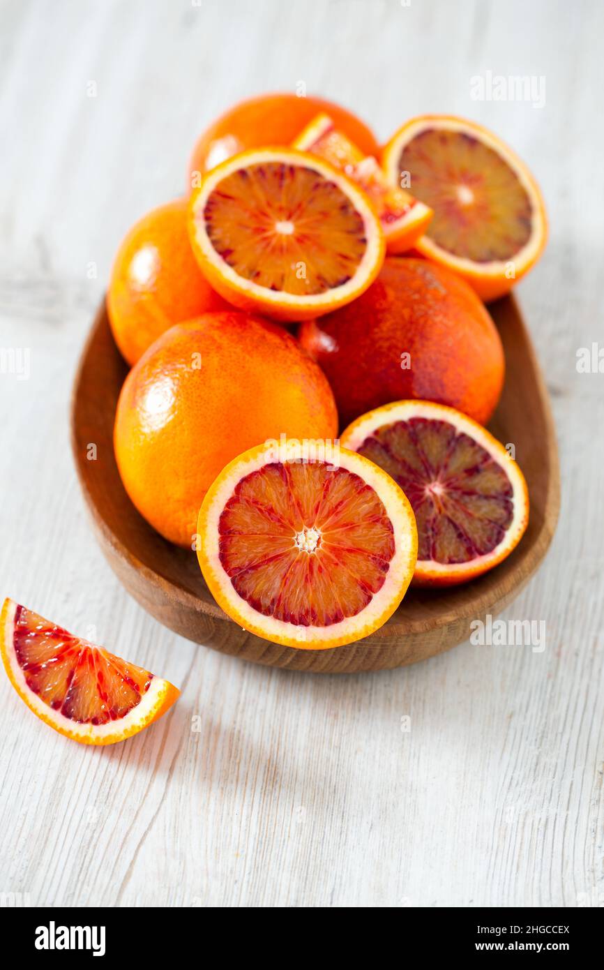 cut blood oranges on wooden surface Stock Photo - Alamy
