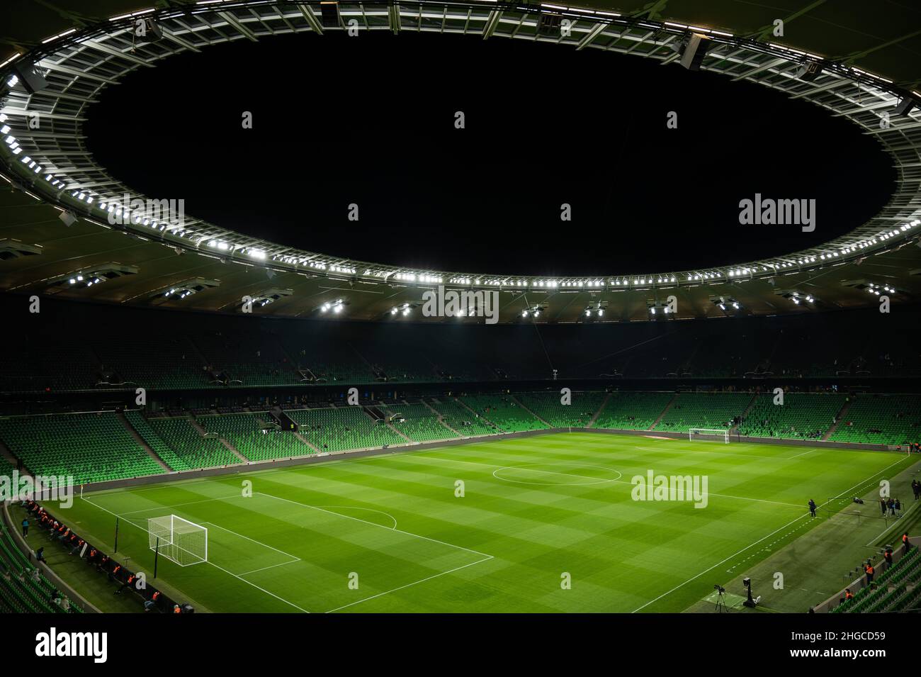 An open football stadium with empty stands with green seats Stock Photo ...