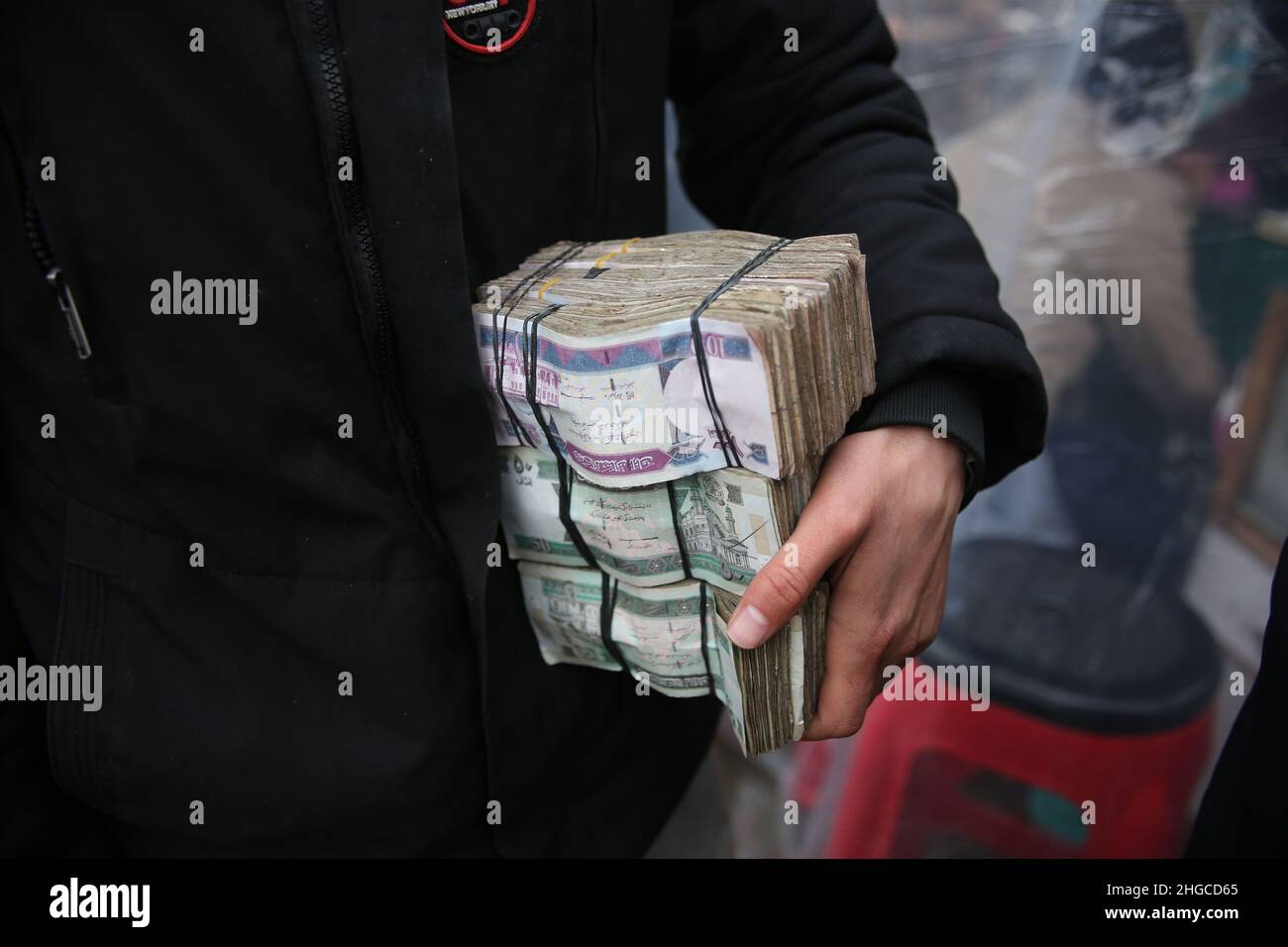 Kabul, Afghanistan. 19th Jan, 2022. A money exchanger holds banknotes ...