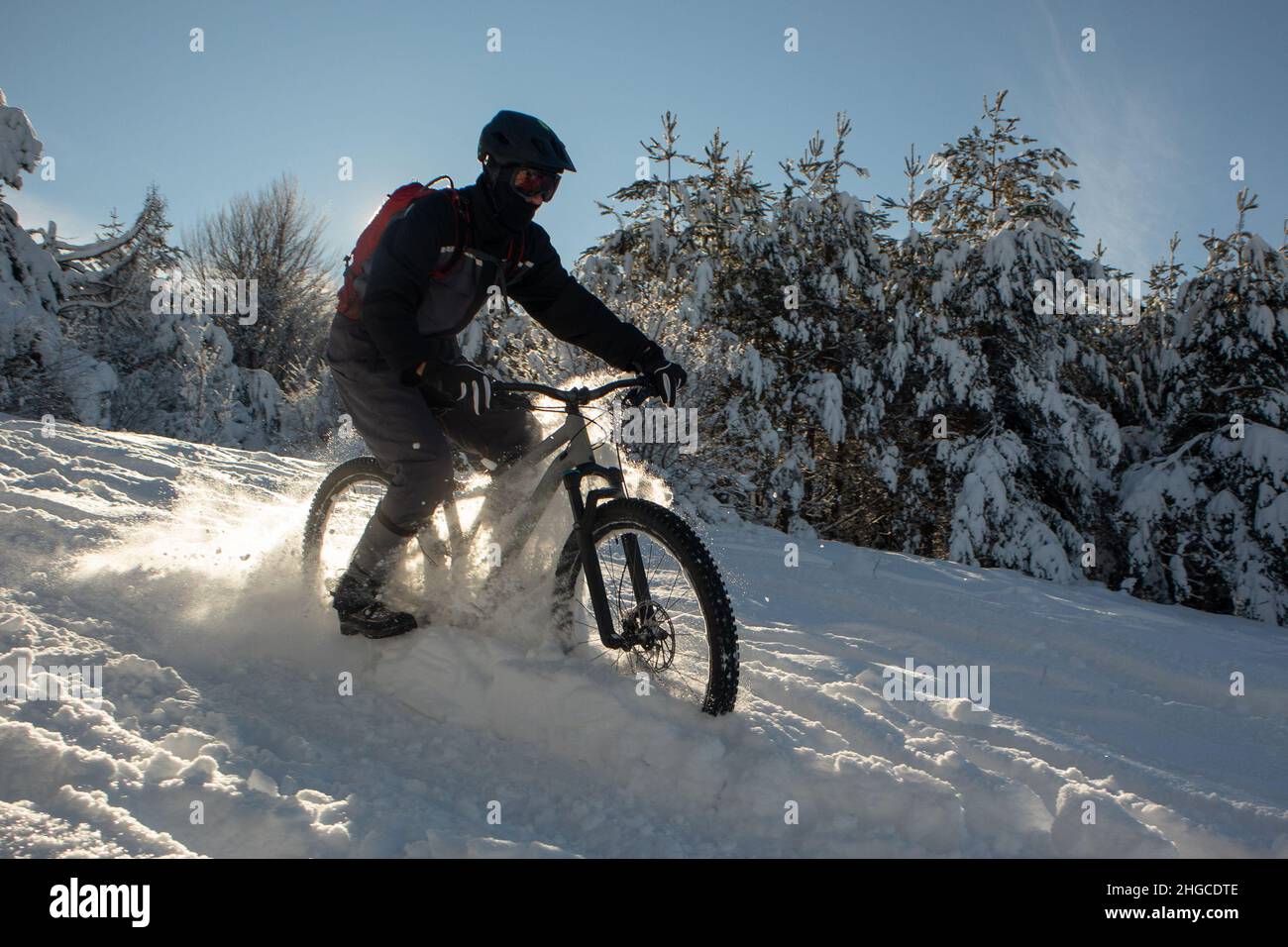 Snowy descent with a mountain bike. Snow downhill with bike, mtb action ...