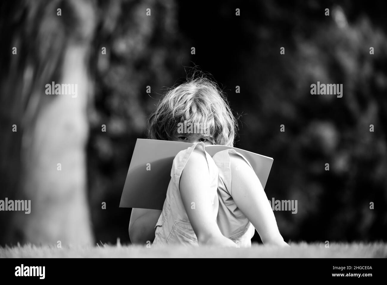 Distance children education. Cute pupil writing at notebook at the ...