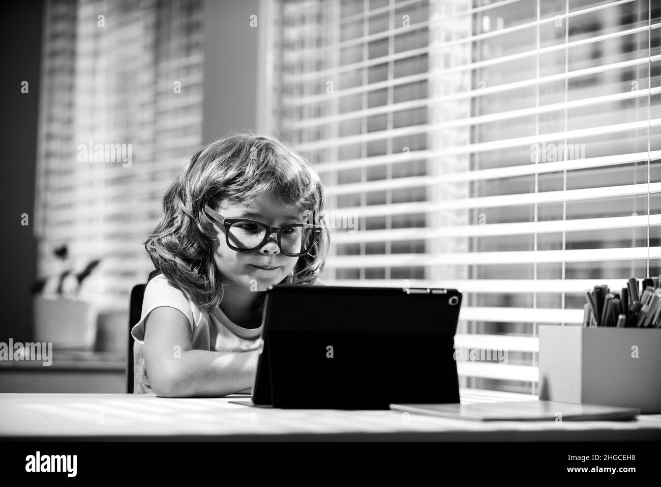 Smart little boy watch online video lesson at home, small child in ...