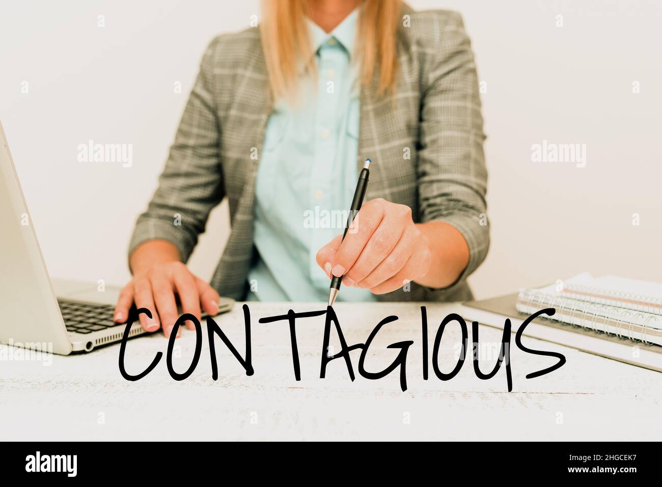 Hand writing sign Contagious. Word for transmissible by direct or ...