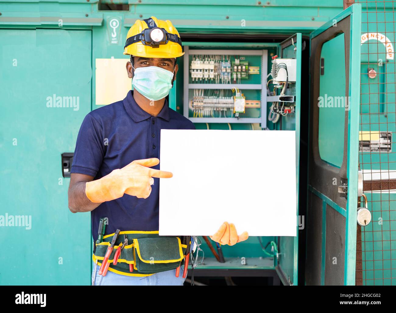 Electrician with meidcal face mask and safety Stock Photo - Alamy