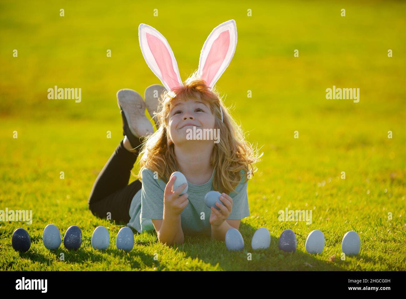 Kids boy hunting easter eggs outdoor. Child having fun in park. Easter ...