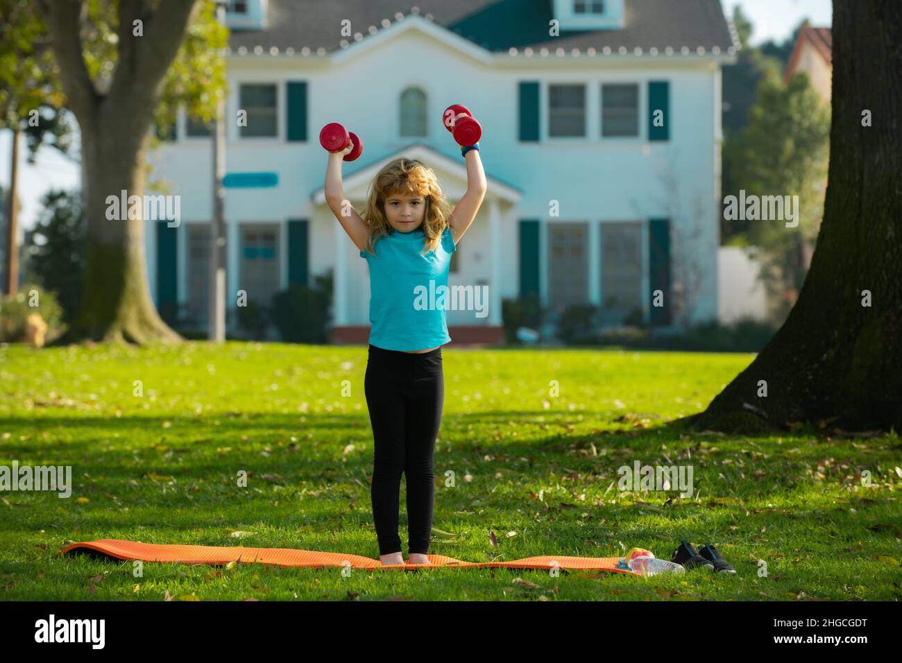 Kids morning sports exercises. Sport children. Sport child with strong biceps muscles. Kids ...