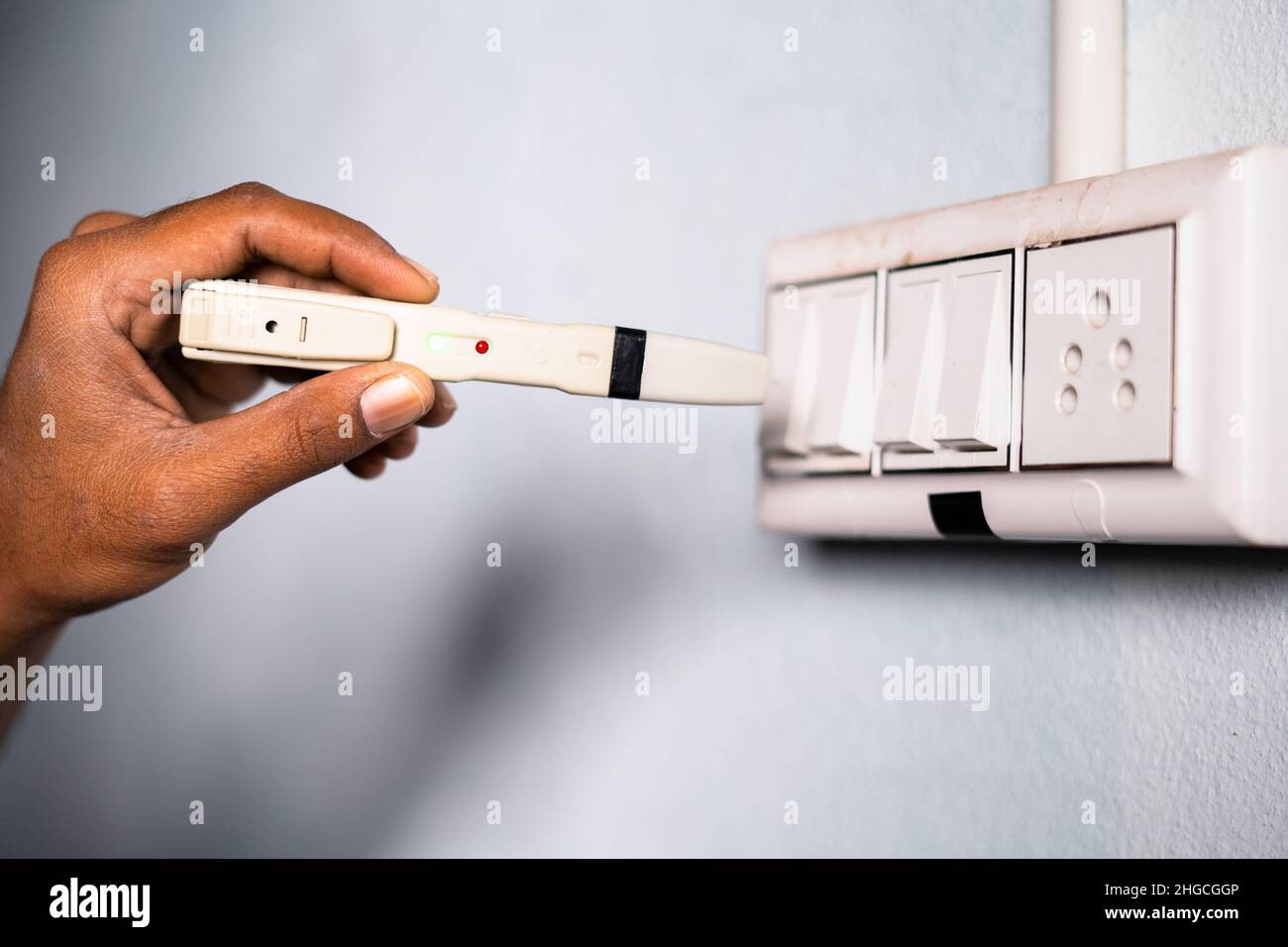 Close up of unrecognizable electrician checking circuit using ...